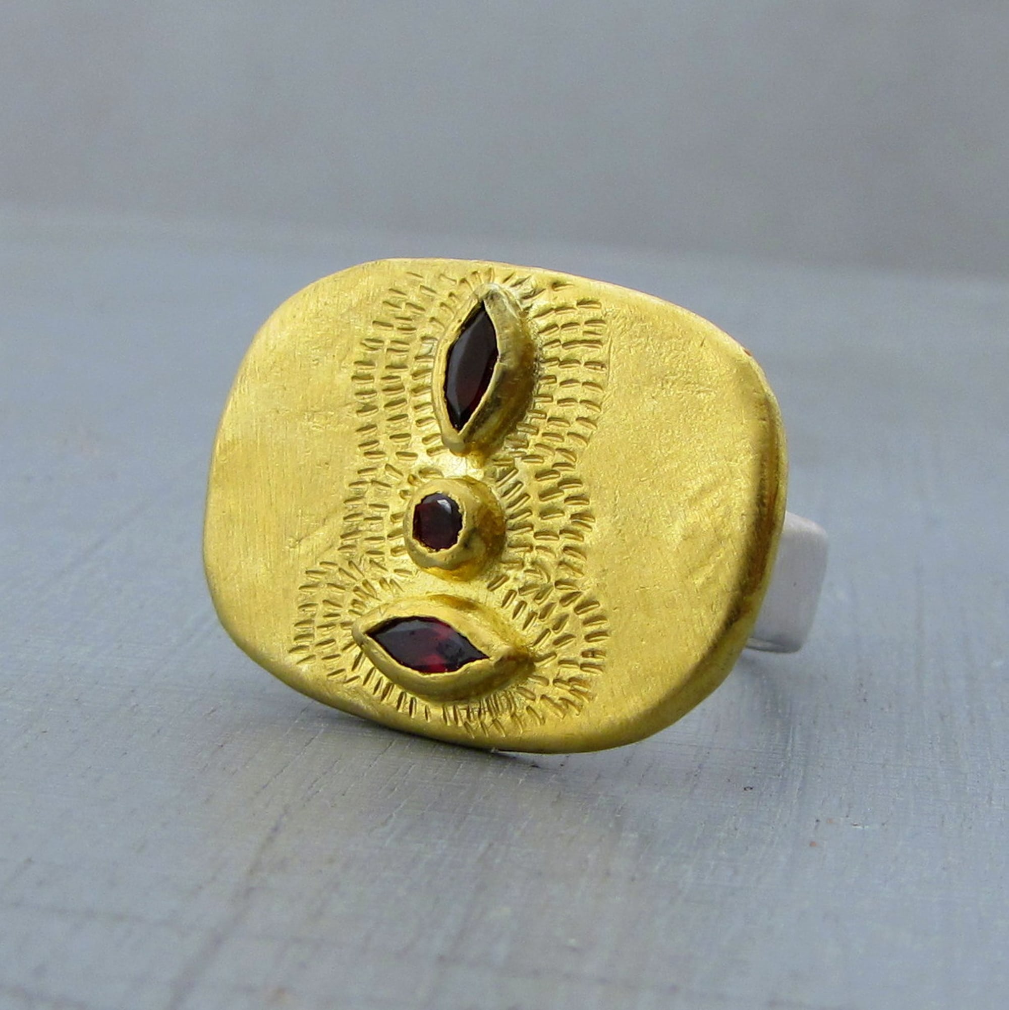 Beautiful Garnets set in 24k gold basil in the center of the ring