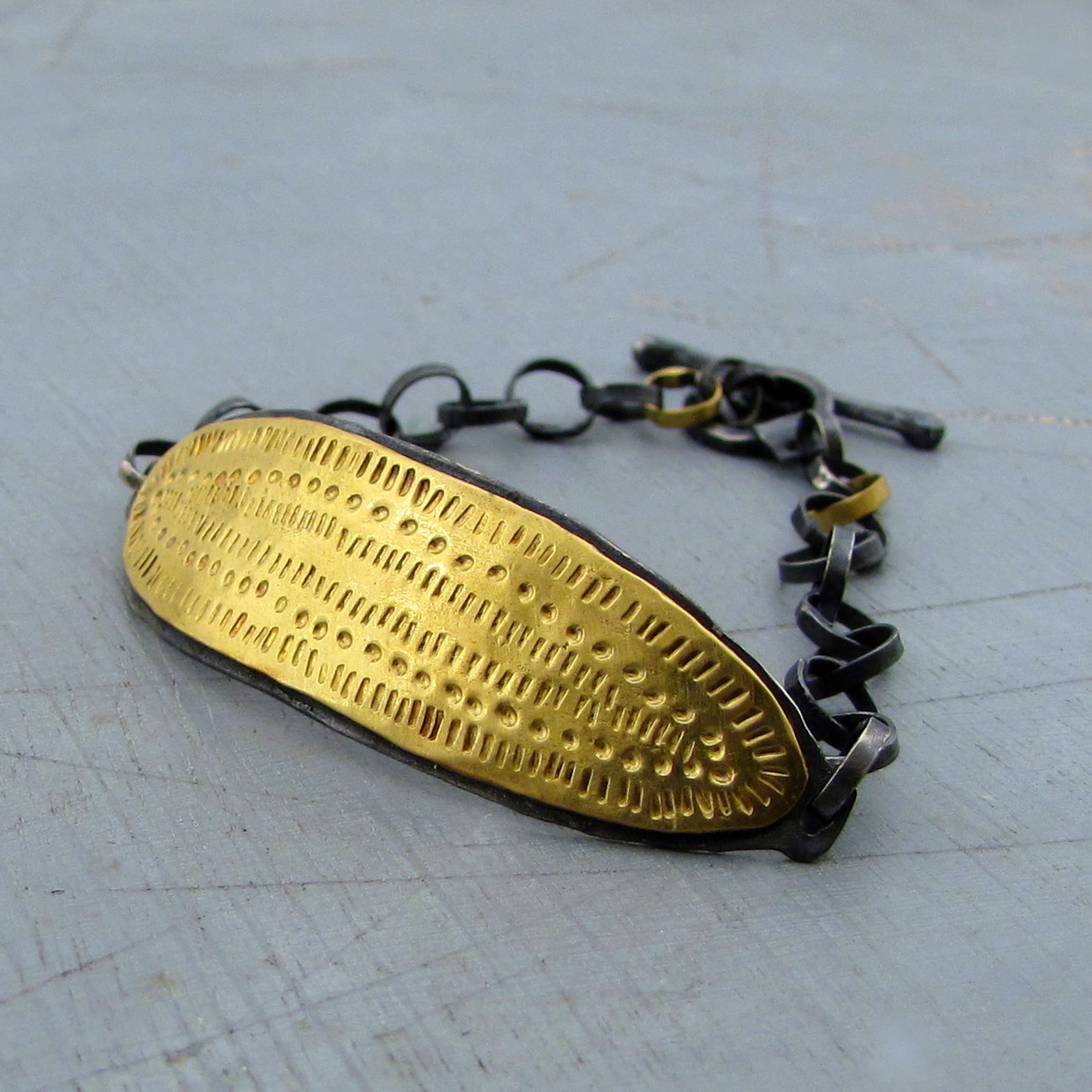 Handmade textured wide 22k gold bar and silver bracelet