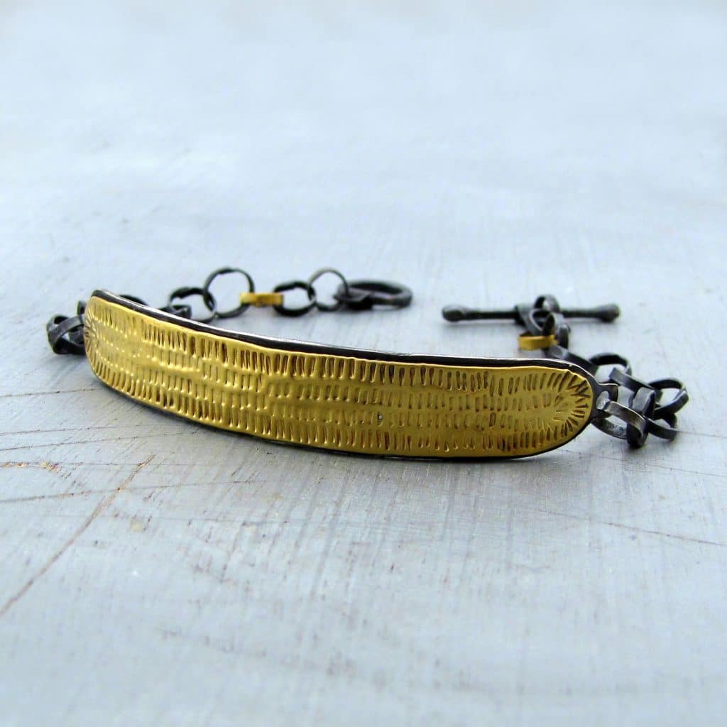 Handmade textured 22k gold bar and silver bracelet